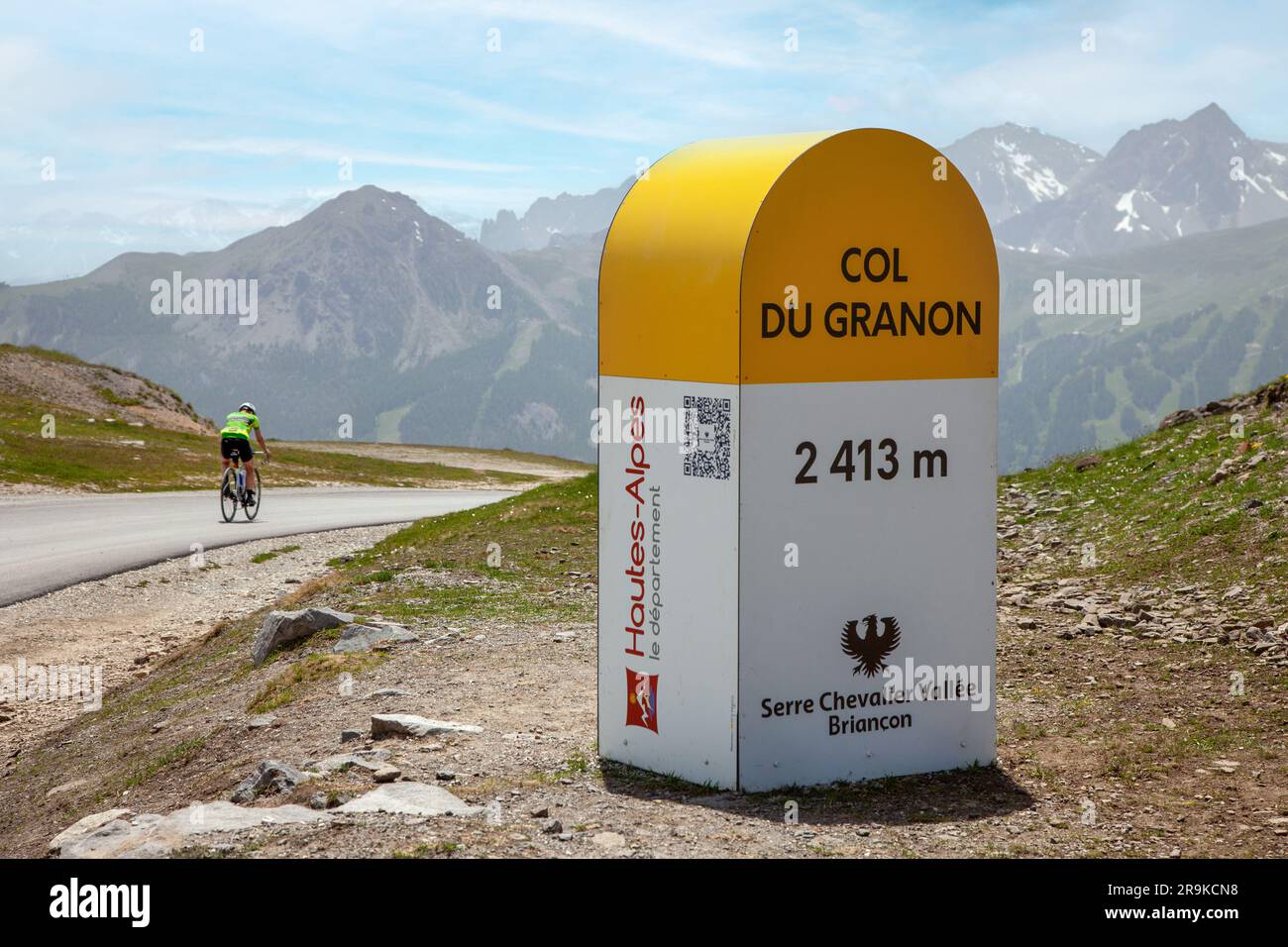 Col du Granon summit marker and cyclist, Hautes-Alpes, France Stock ...