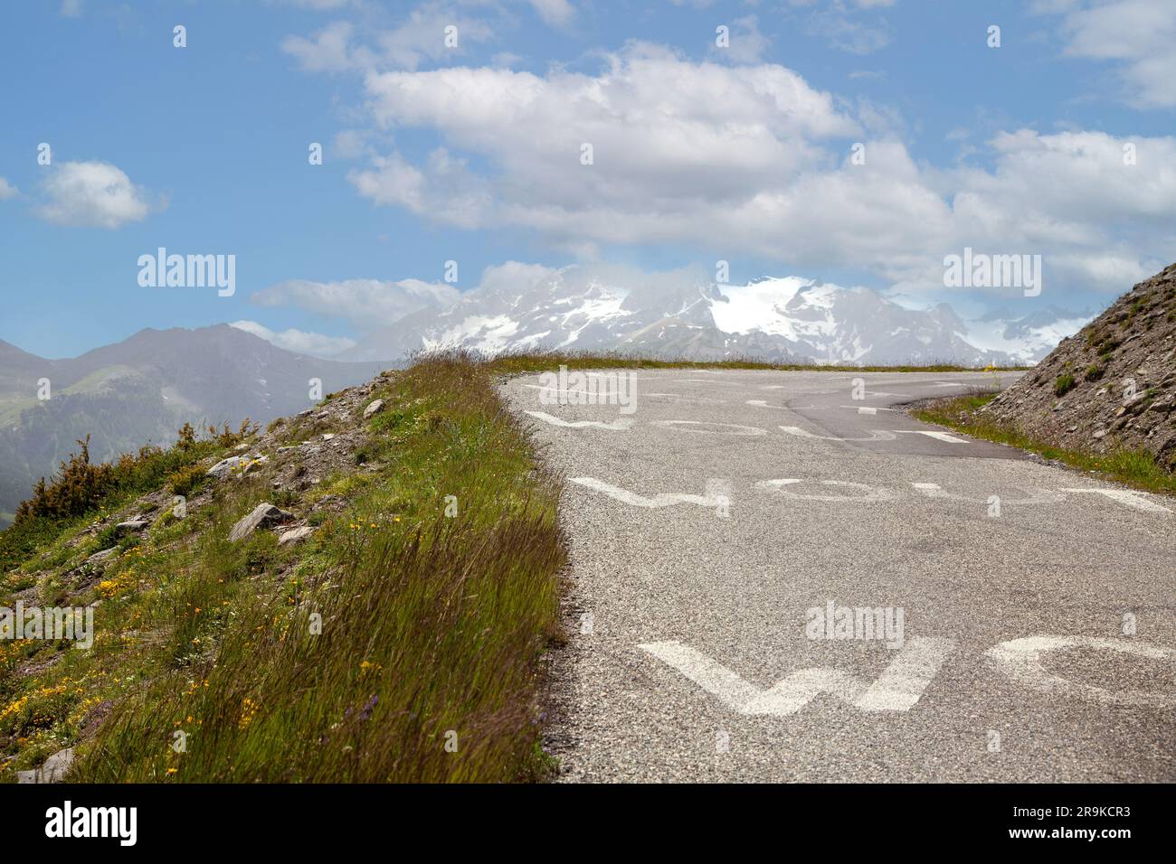Col du Granon climb showing mountain and wout painting on road, Hautes ...
