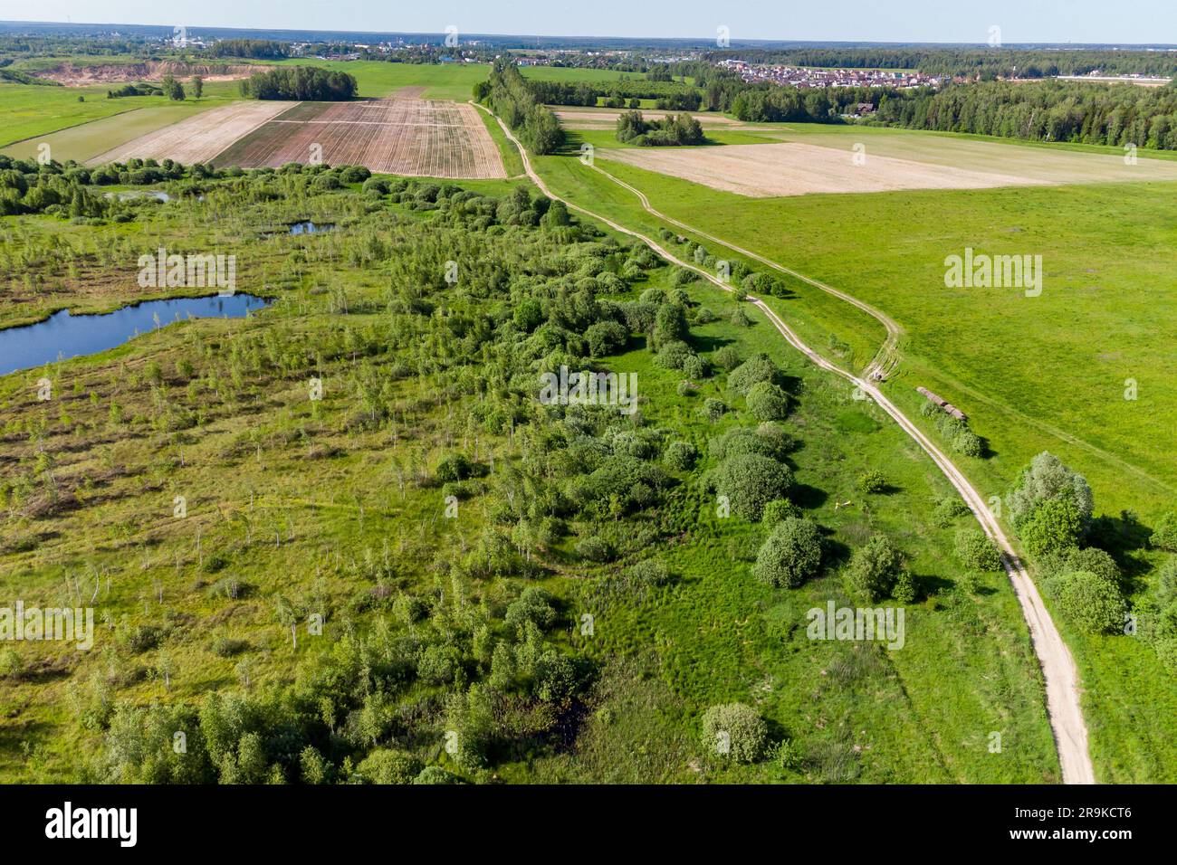 A view from a height of a country road receding into the distance ...