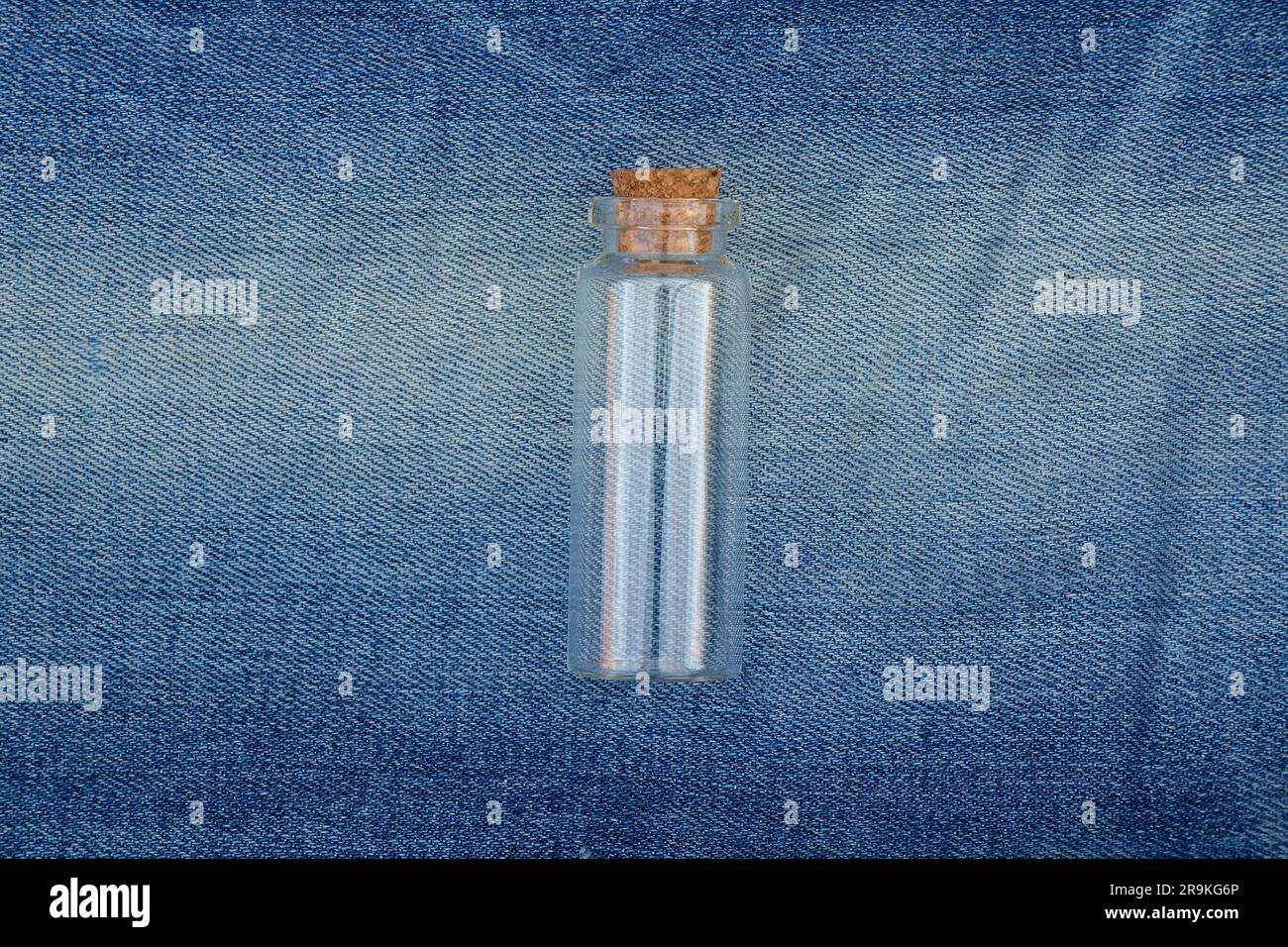 small glass test tube with cork cap on an isolated jeans Stock Photo ...