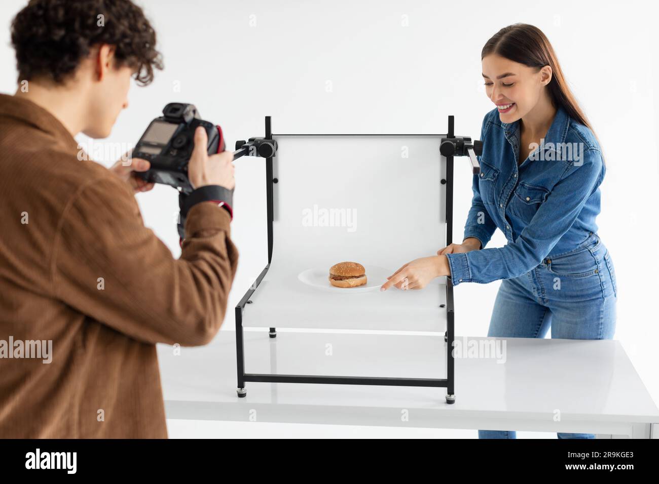 Male photographer and his female assistant doing content photoshoot for ...