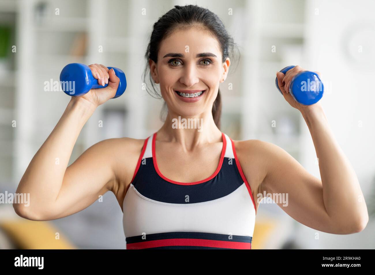 Portrait of happy pretty sporty lady have dumbbells workout Stock Photo ...