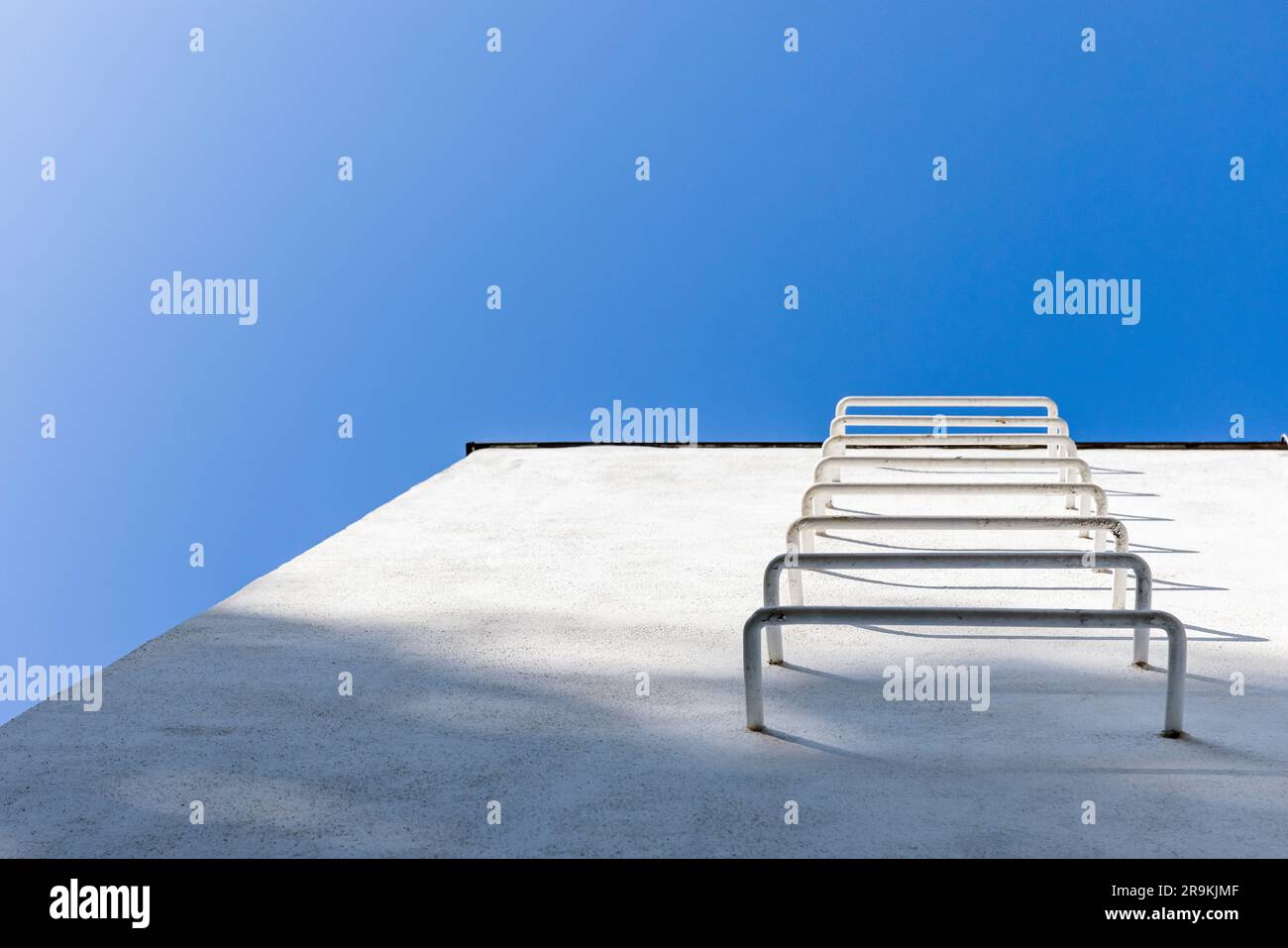 Abstract architecture background, white wall with metal stairs under ...