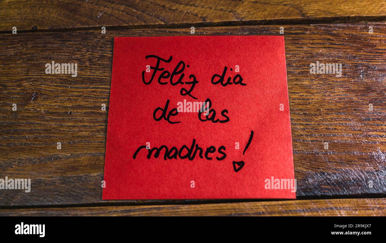 Writing happy mother`s day in Spanish (feliz dia de las madres) on memo ...
