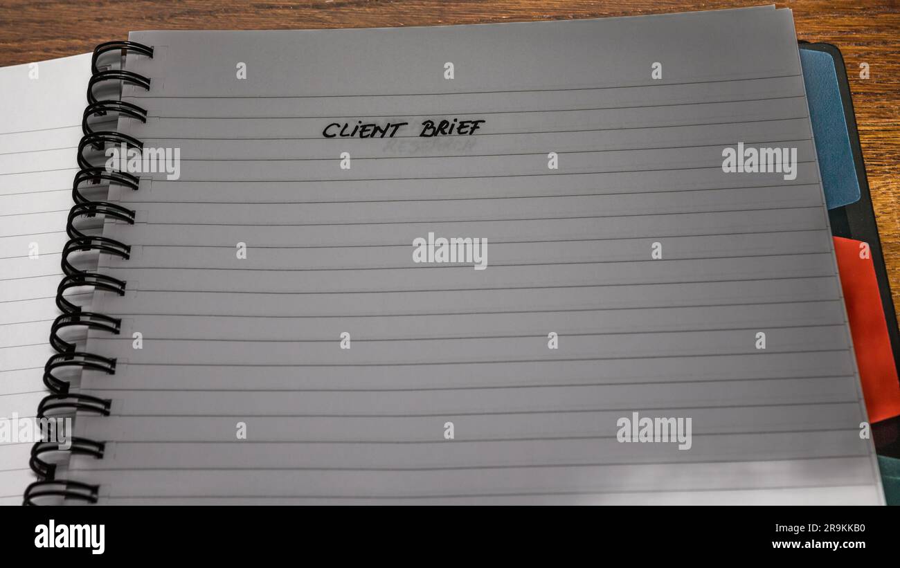 Client brief, handwriting text on page of office agenda, office spiral ...
