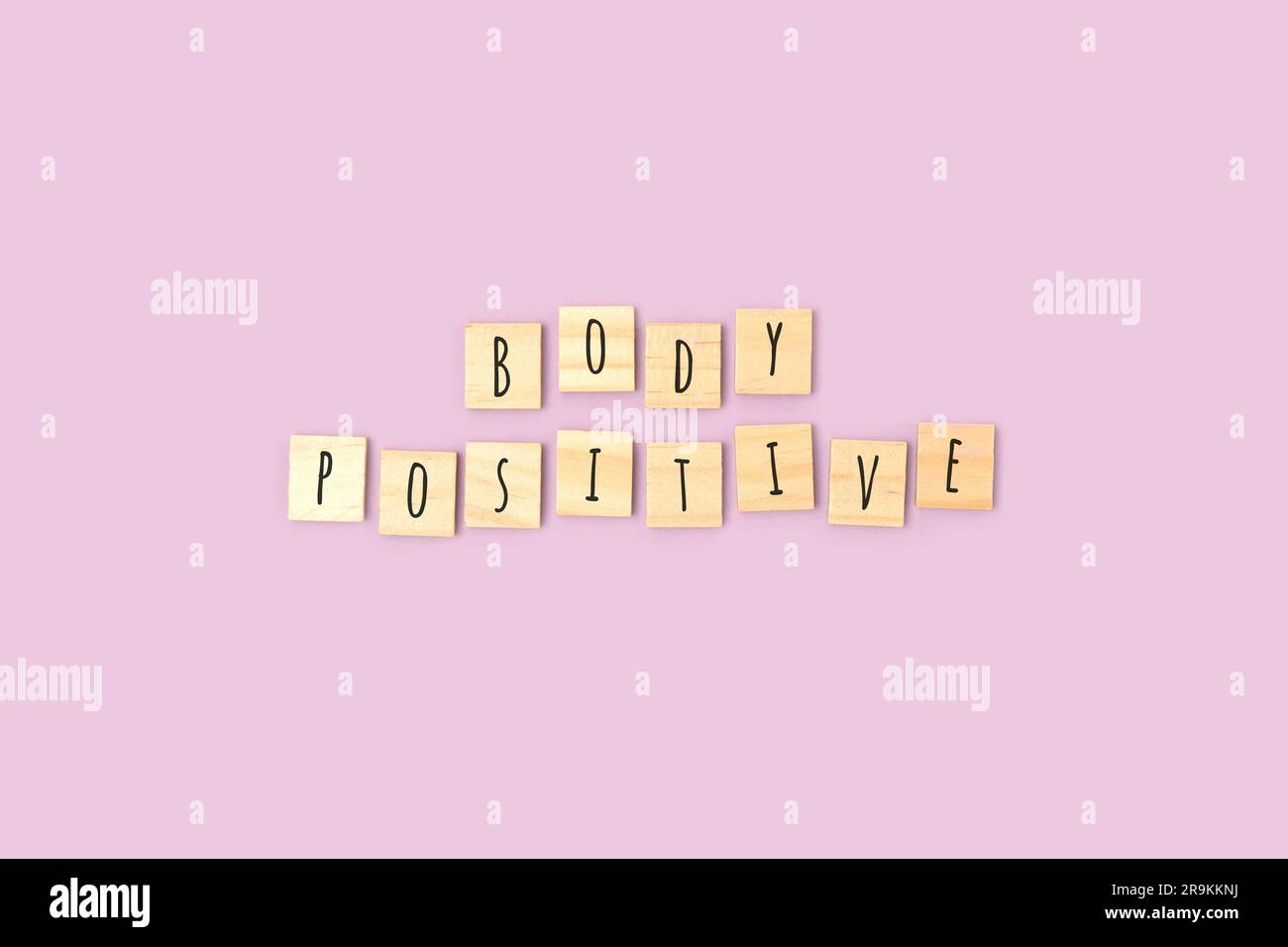 Body positive. Quote made of wooden blocks with letters on a purple ...