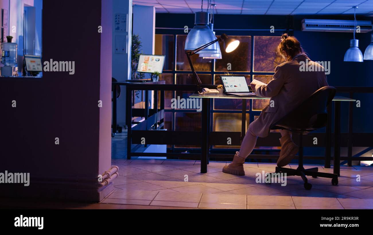 Advisor agent checking corporate report late at night, working overtime ...