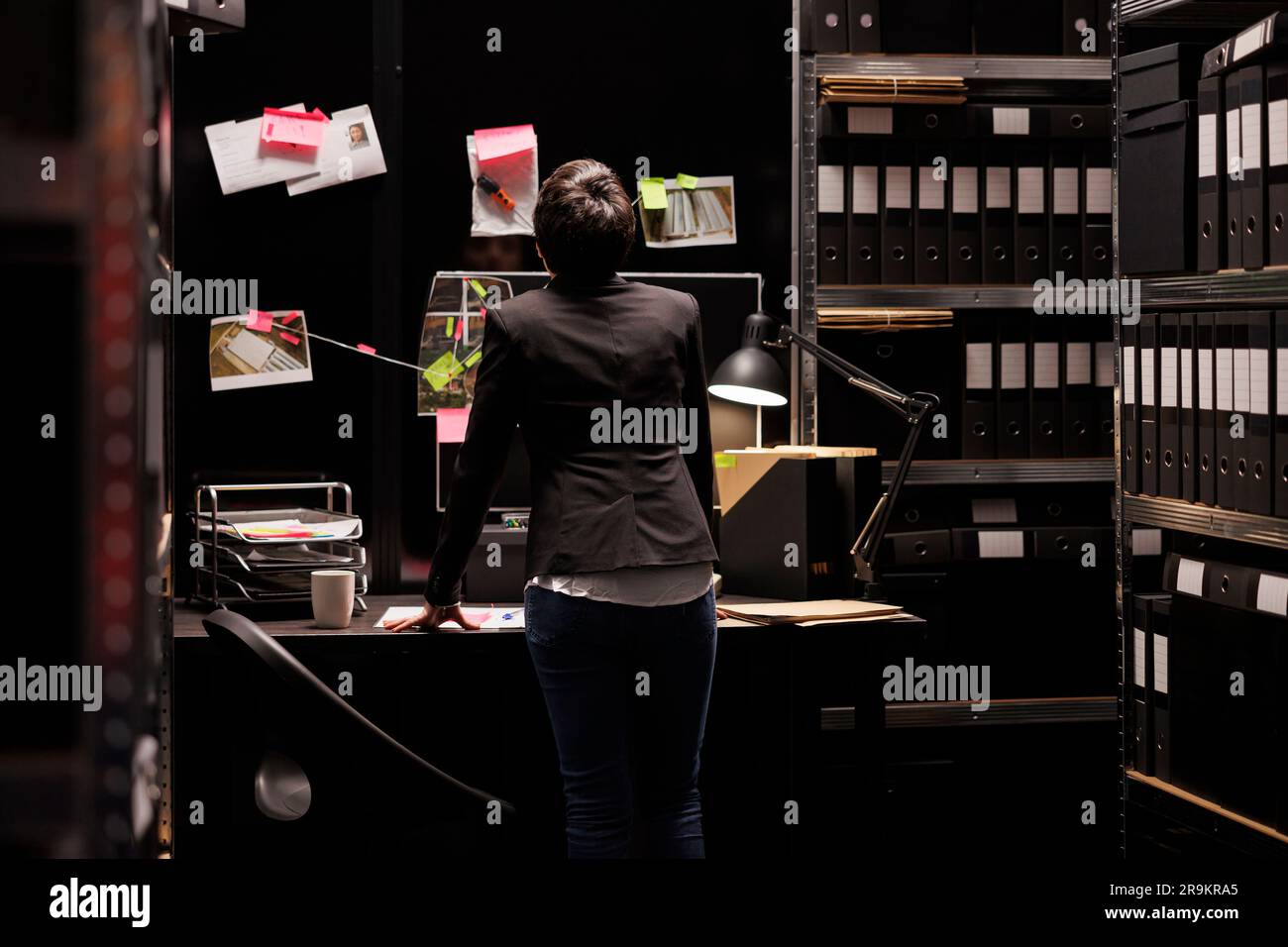 Criminology inspector looking at investigation board analyzing ...