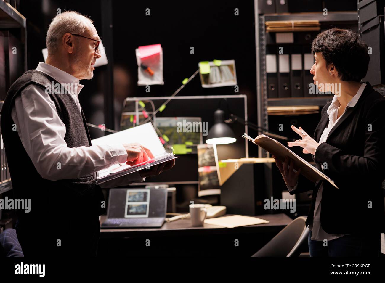 Senior police officer checking crime evidence, discussing criminology ...