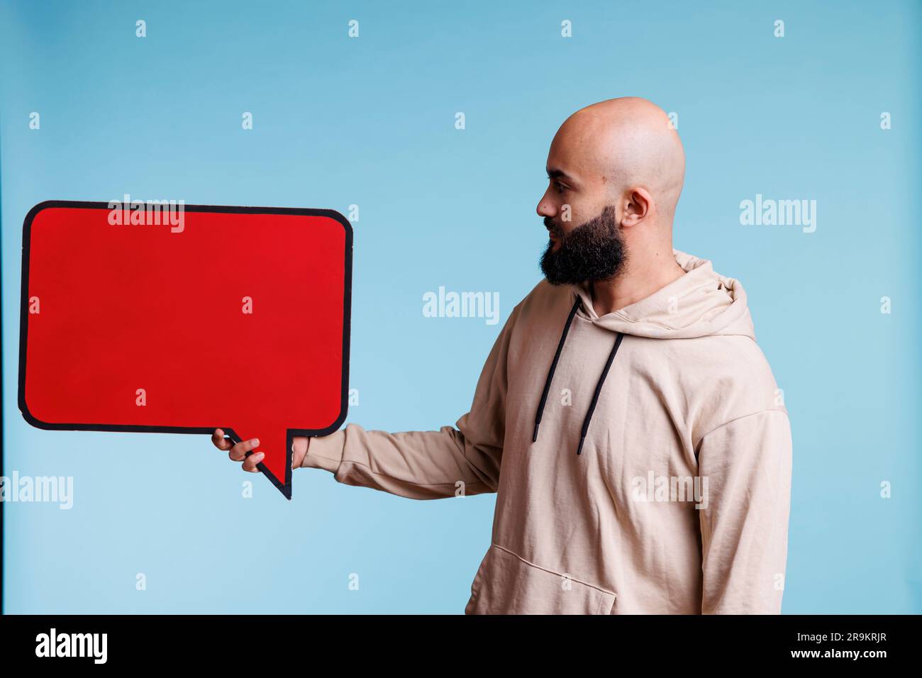 Arab man advertising product with empty red banner, showing frame for ...