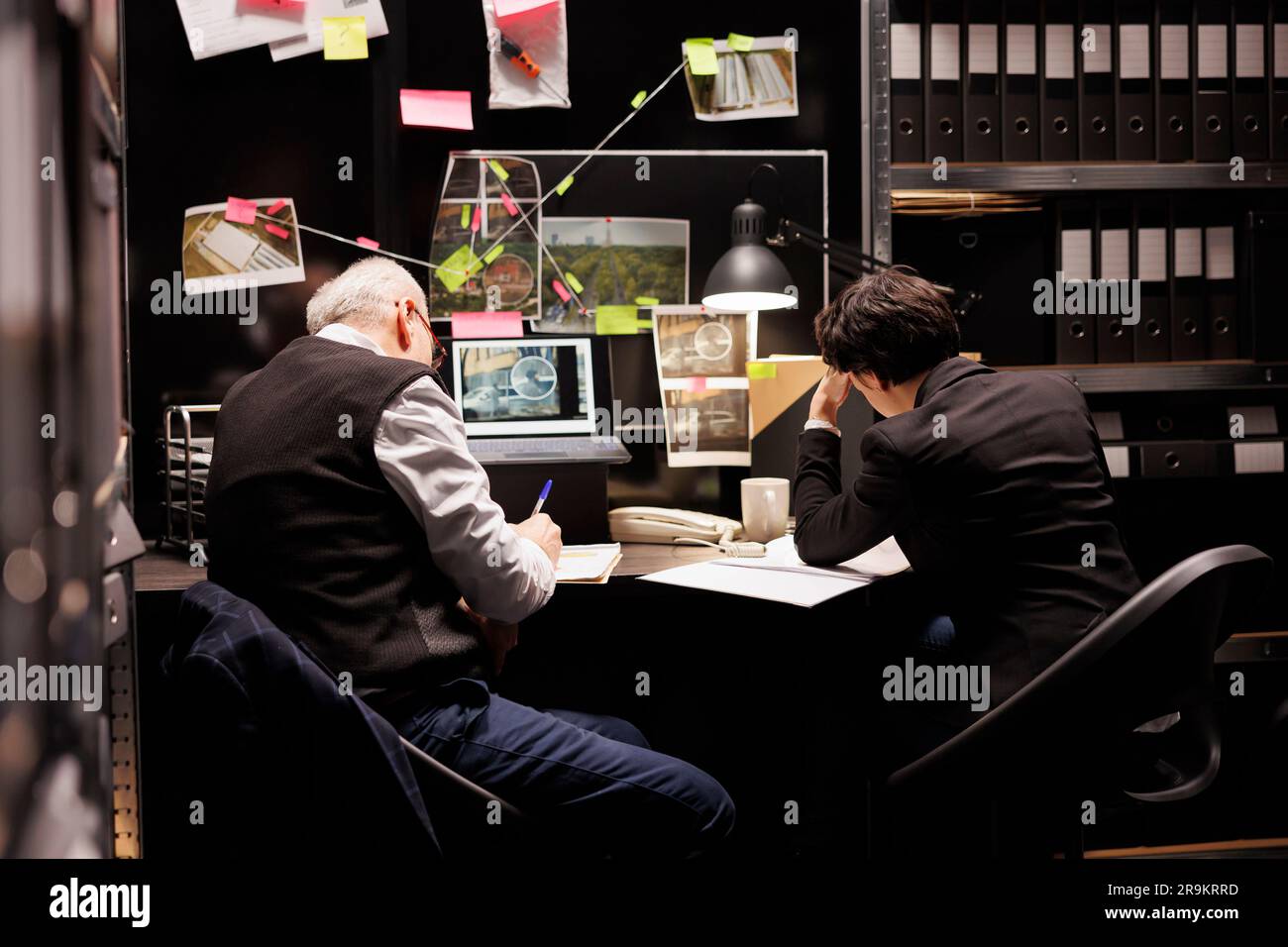 Police officer analyzing federal documents with woman inspector ...
