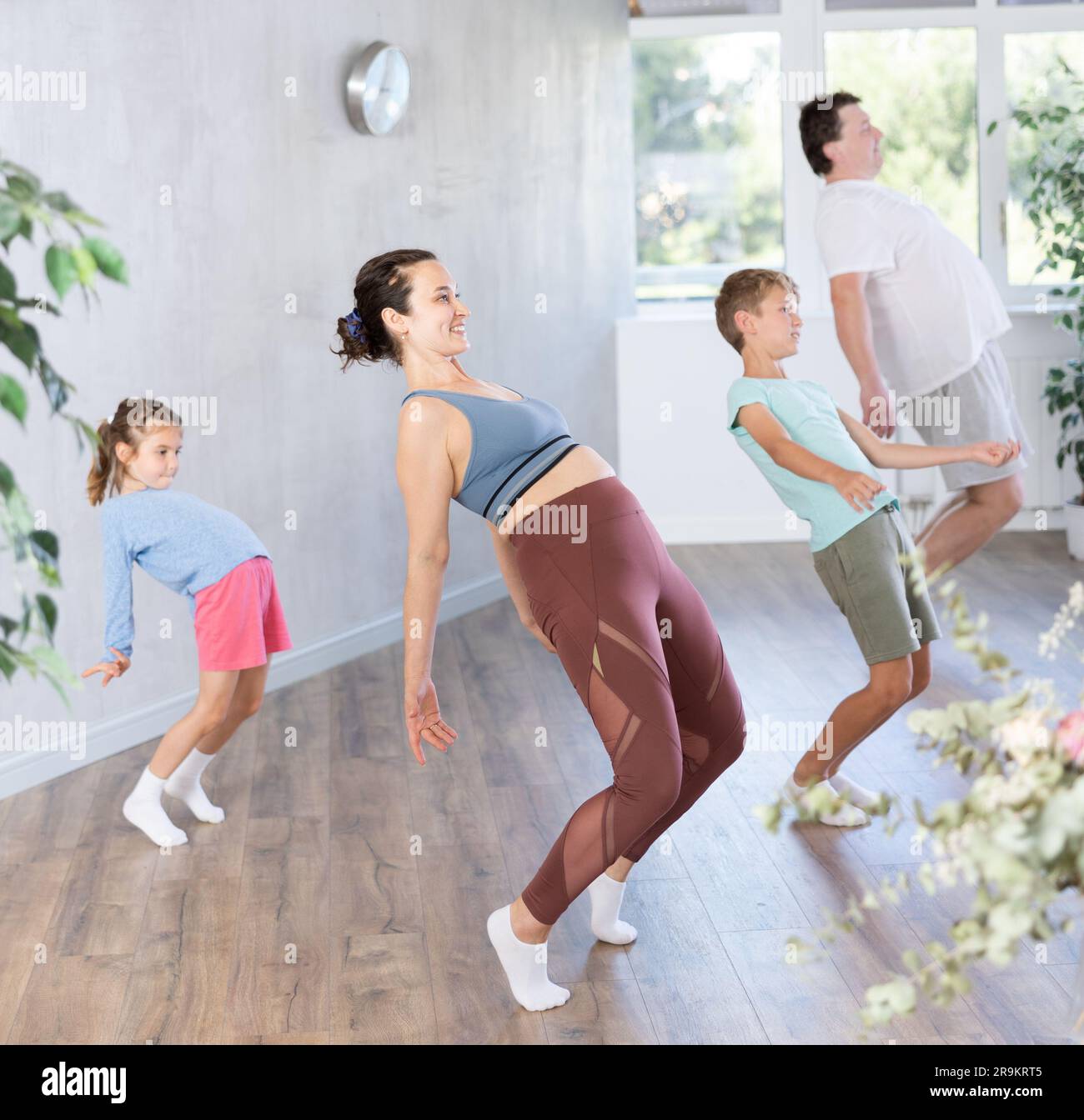 Positive pre teenage dancers and his parent doing dance workout during ...