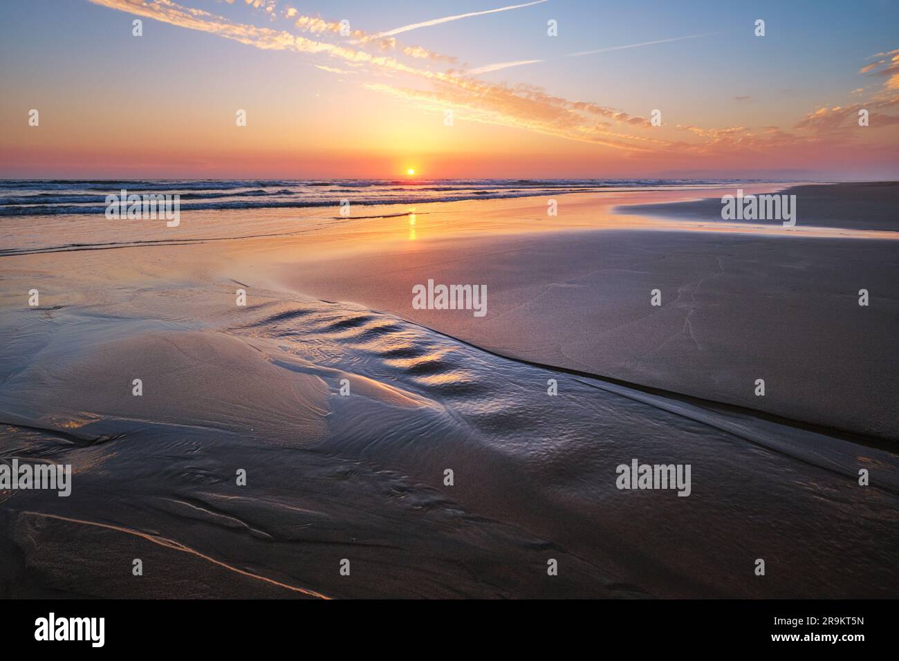 Atlantic ocean sunset with surging waves at Fonte da Telha beach ...
