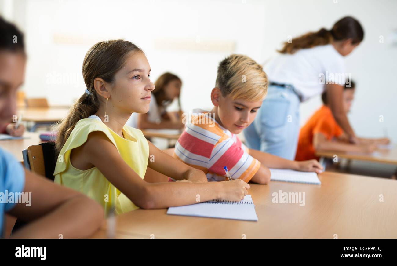 Boy and girl studying in classroom Stock Photo - Alamy