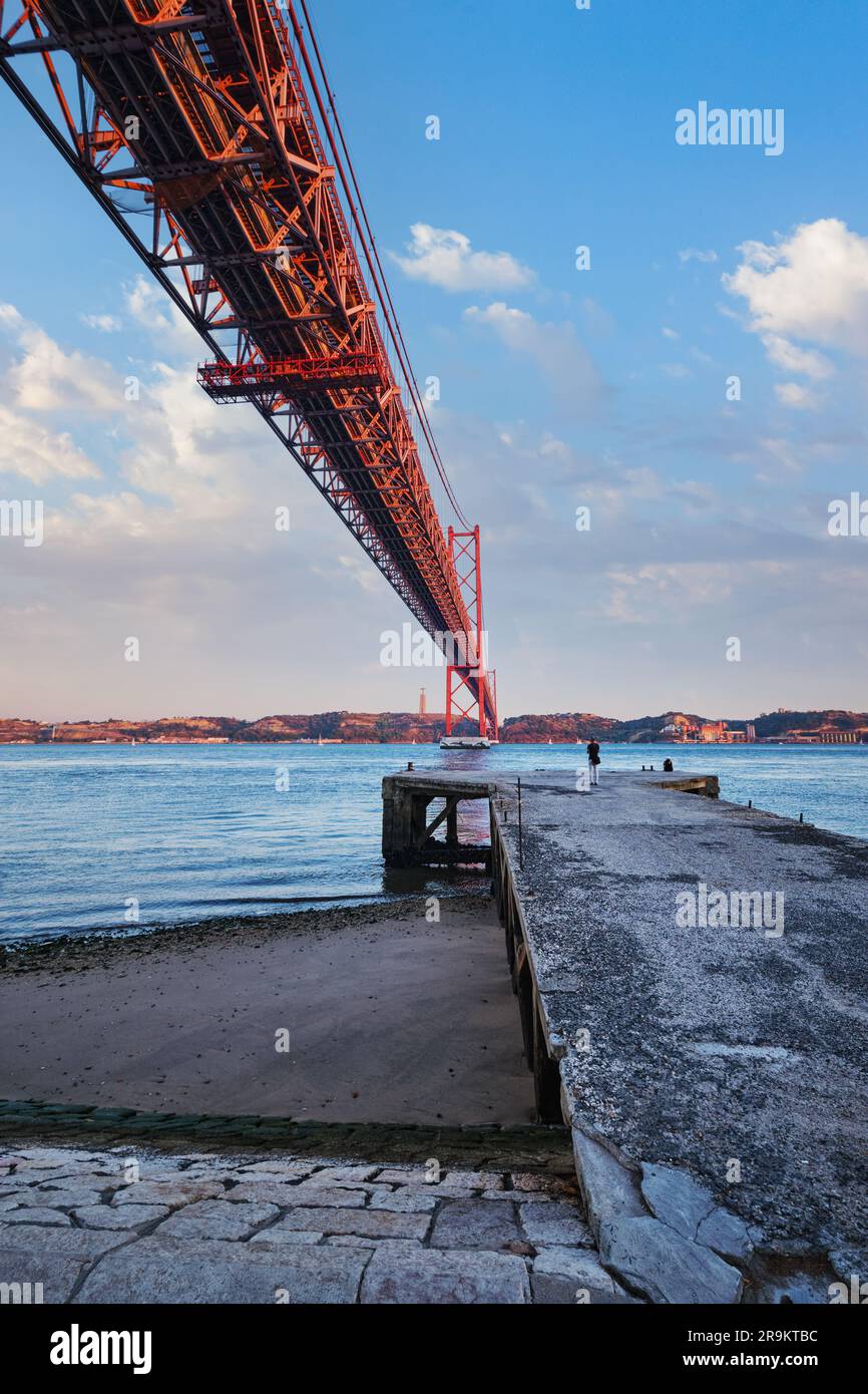 View of 25 de Abril Bridge over Tagus river, Christ the King monument ...