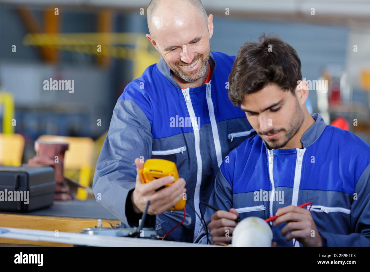 two men measuring the voltage of computer Stock Photo - Alamy