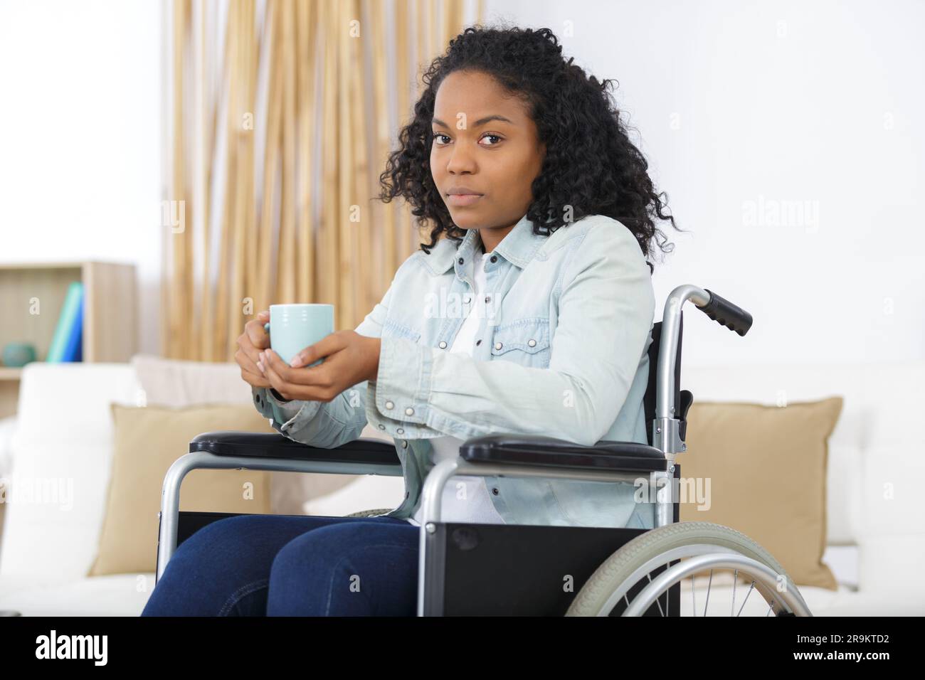 beautiful young disabled woman in wheelchair at home Stock Photo - Alamy
