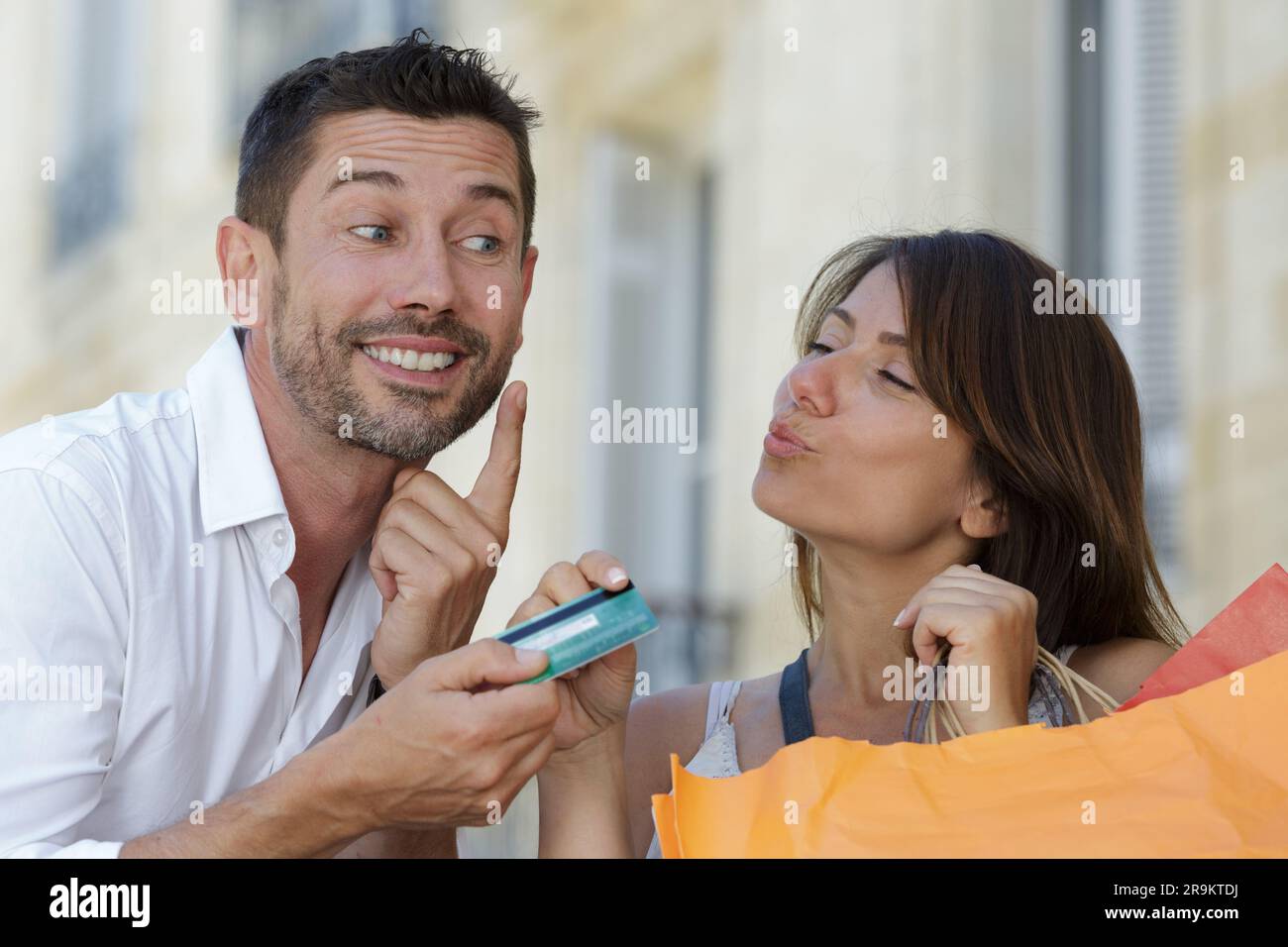 boyfriend asking for a kiss in exchange for credit card Stock Photo - Alamy