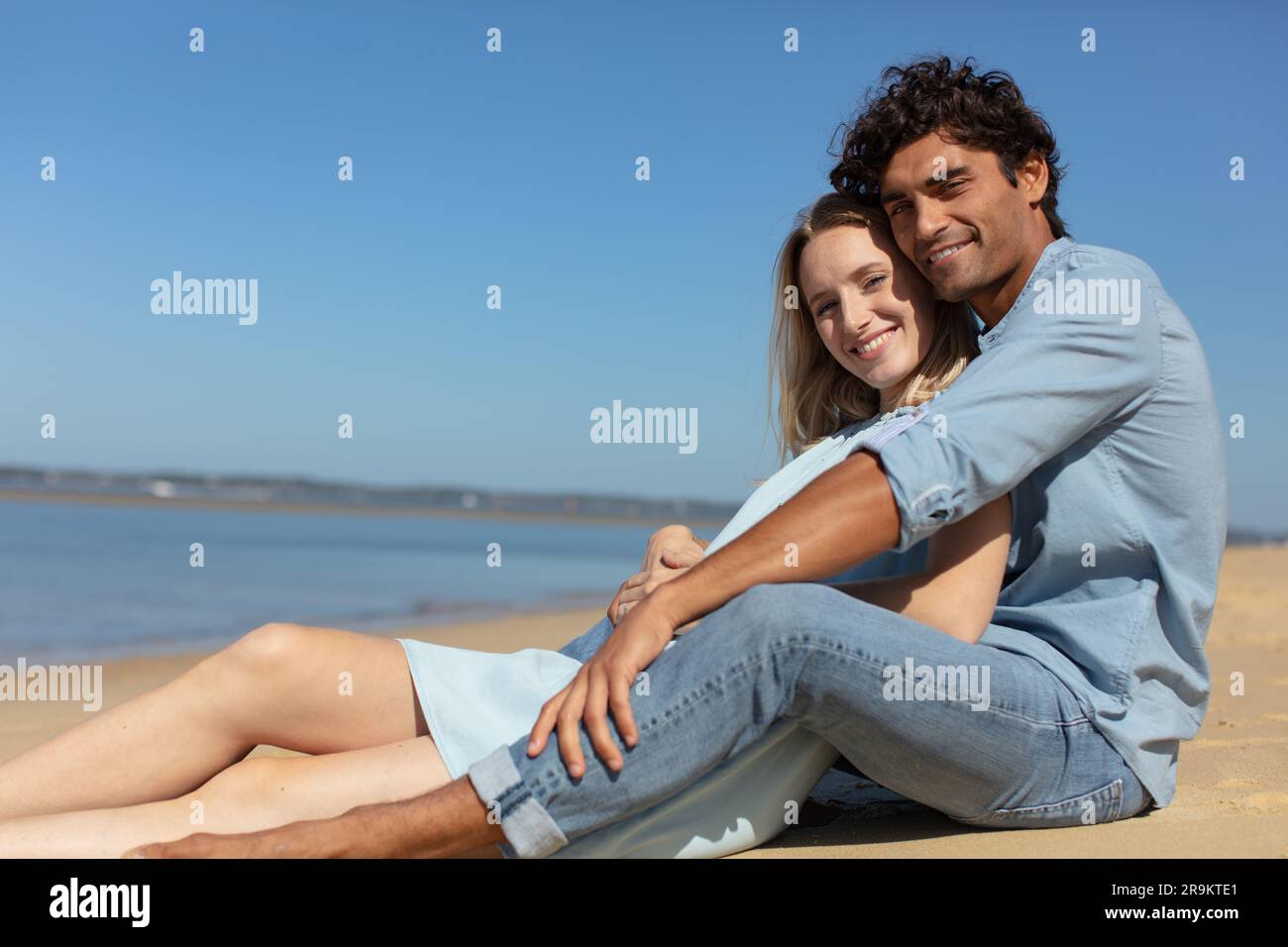 attractive couple cuddling at the beach Stock Photo - Alamy
