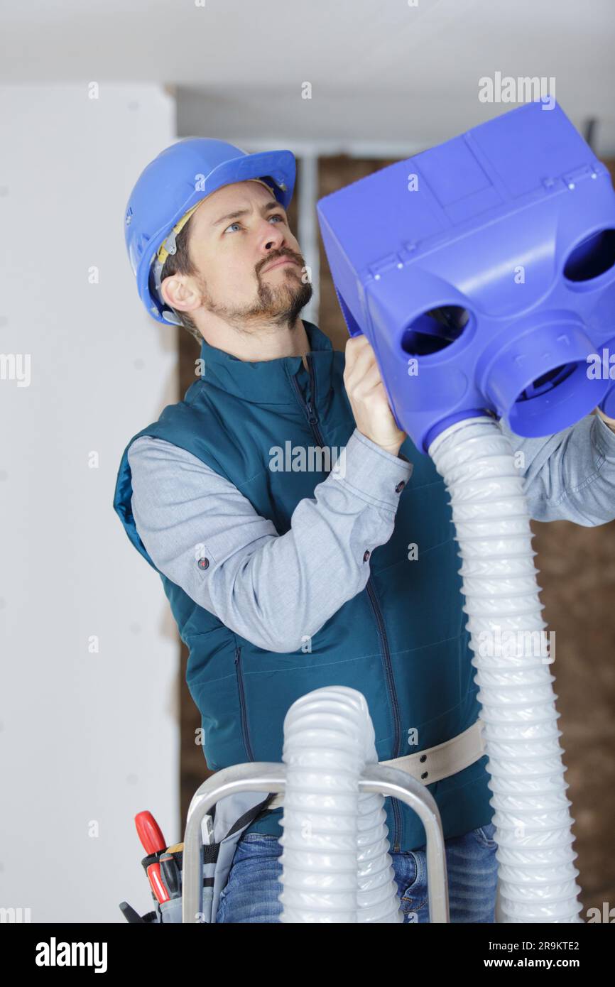 man repairing electrical wiring box Stock Photo - Alamy