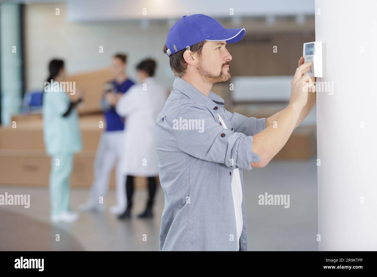 male technician installing alarm system indoors Stock Photo - Alamy