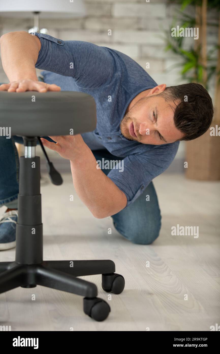 happy man in fixing a chair Stock Photo - Alamy