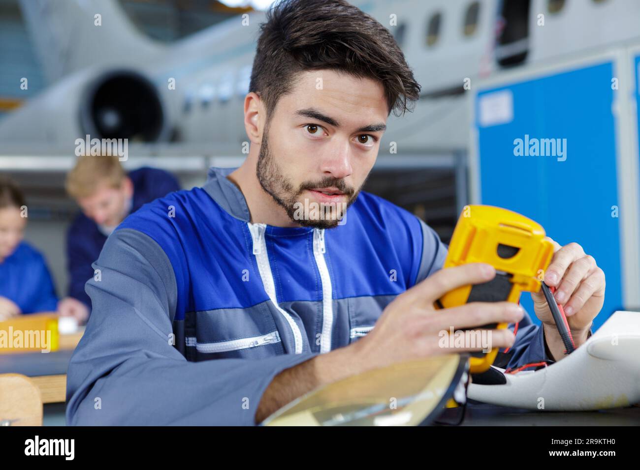 man measures the voltage at the terminal Stock Photo - Alamy
