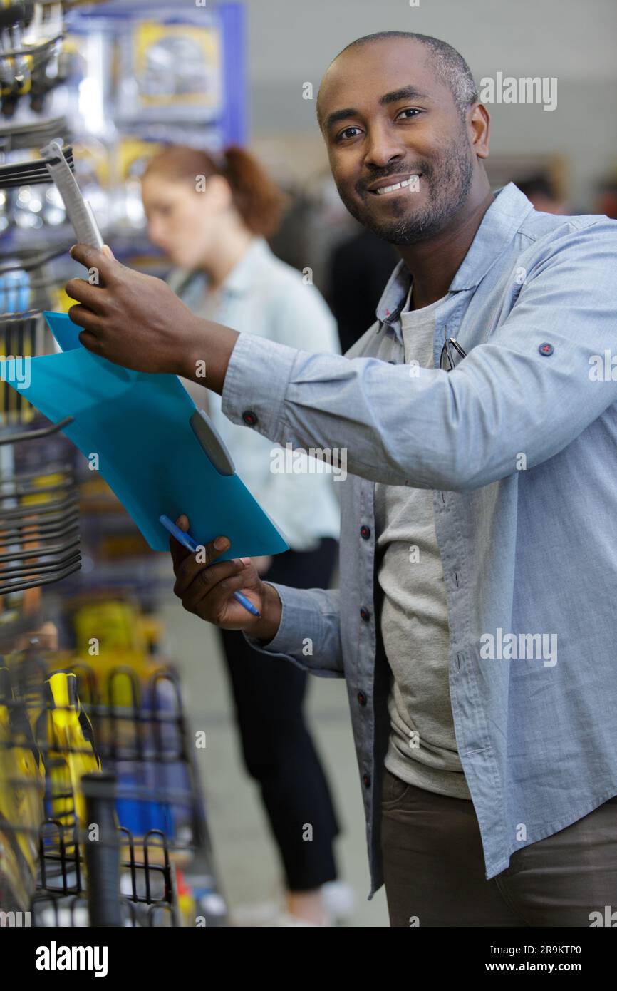 handsome man shopping tools at hardware store Stock Photo - Alamy