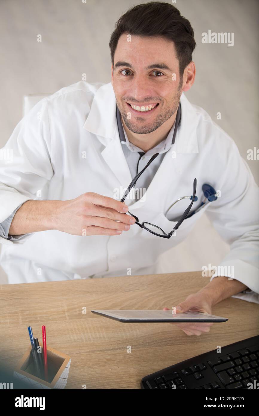 happy doctor reading medical documentation Stock Photo - Alamy