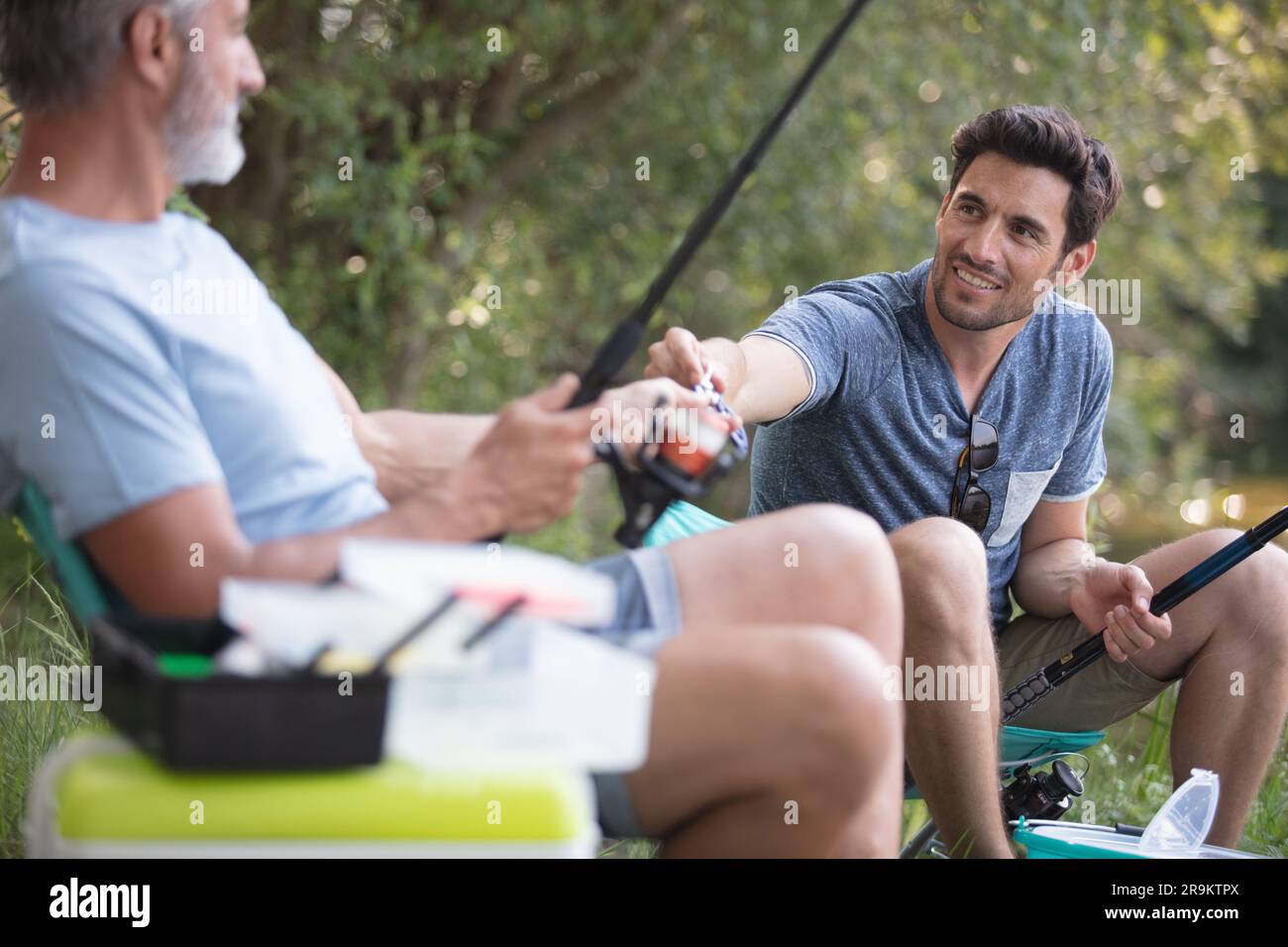 two men fishing in the lake Stock Photo - Alamy