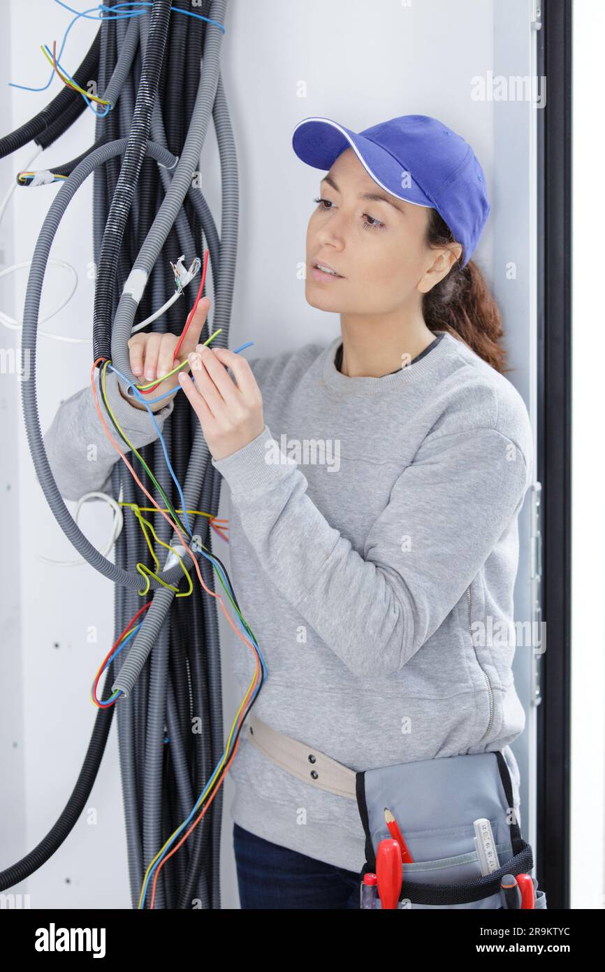 a female electrician fixing socket electricity problem Stock Photo - Alamy