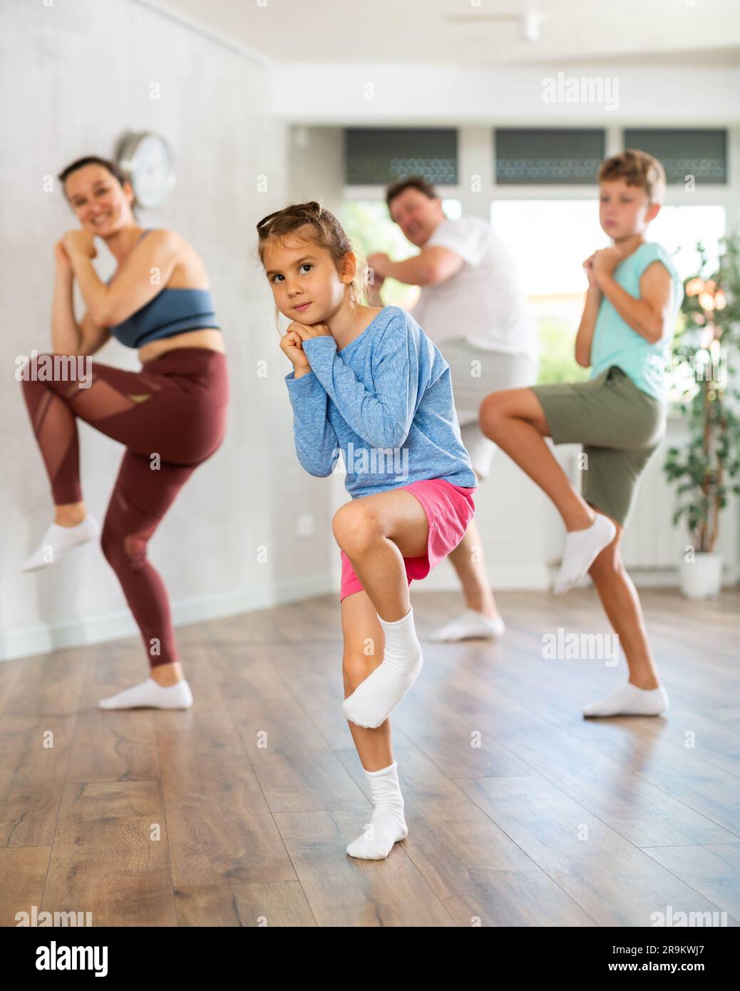 Family with two children dancing in studio Stock Photo - Alamy