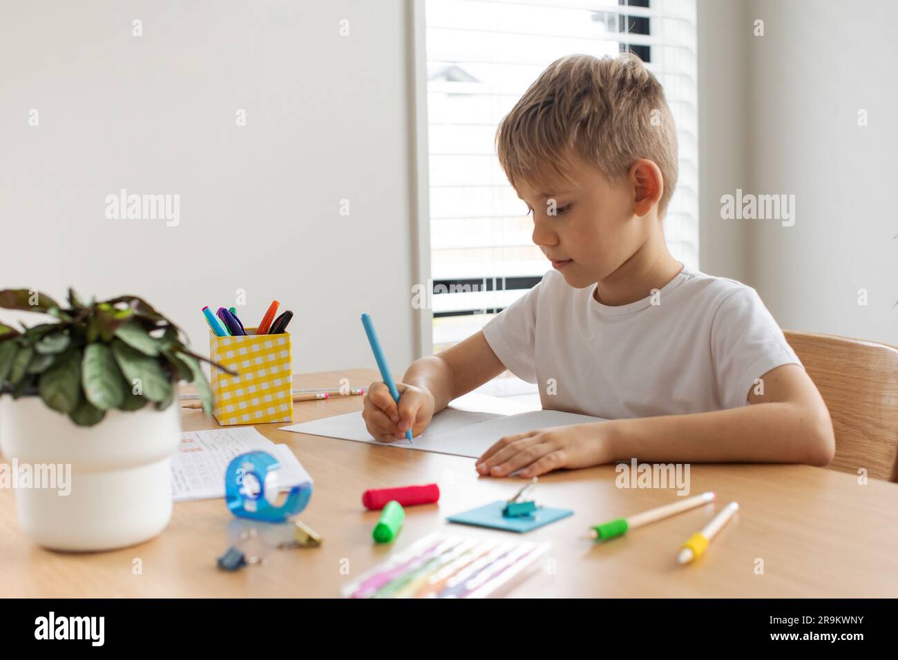 Cute boy doing school homework at home. Distance education. Online ...