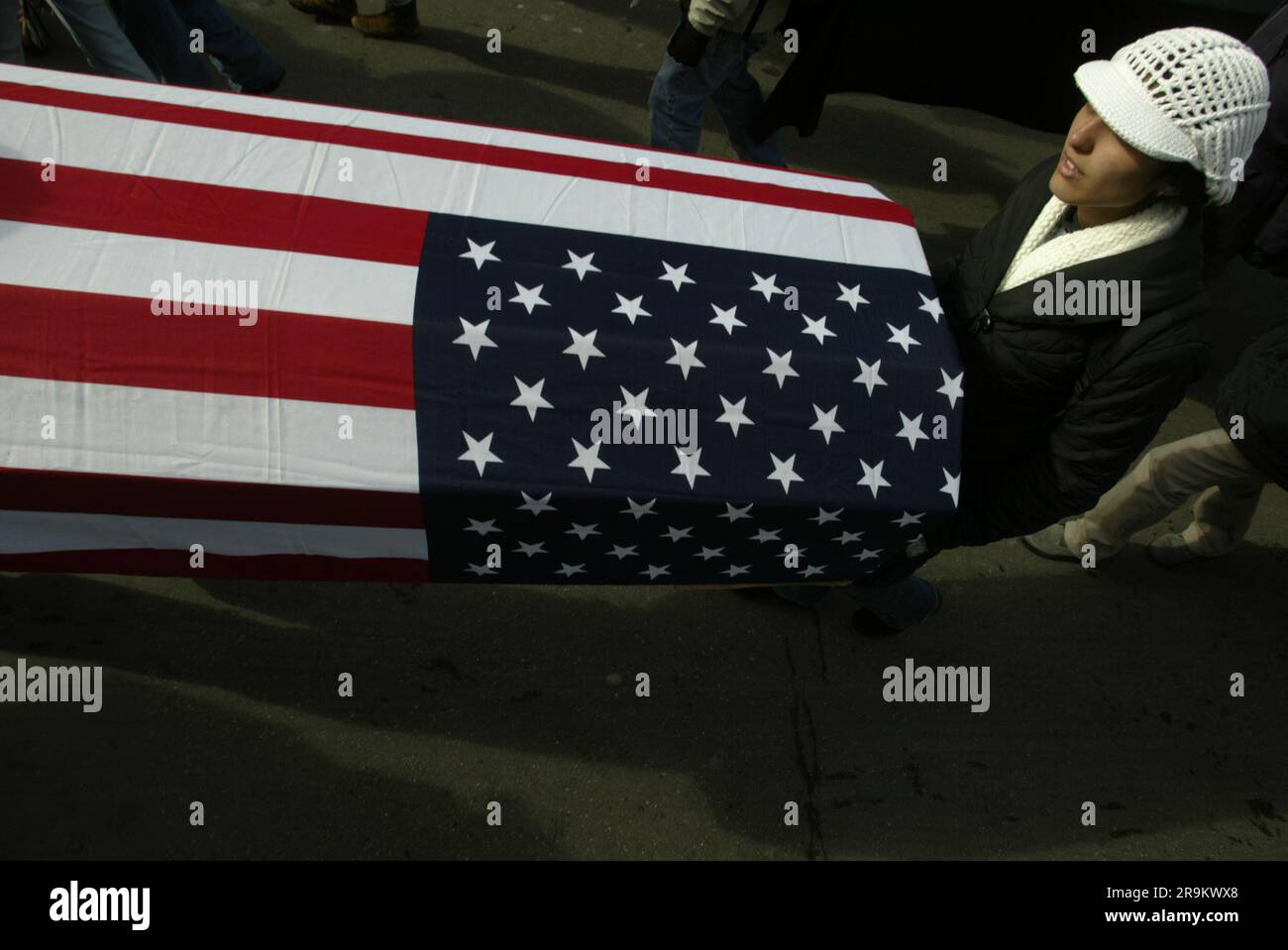 On 16th Street in Washington D.C. a protester carries a symbolic coffin ...