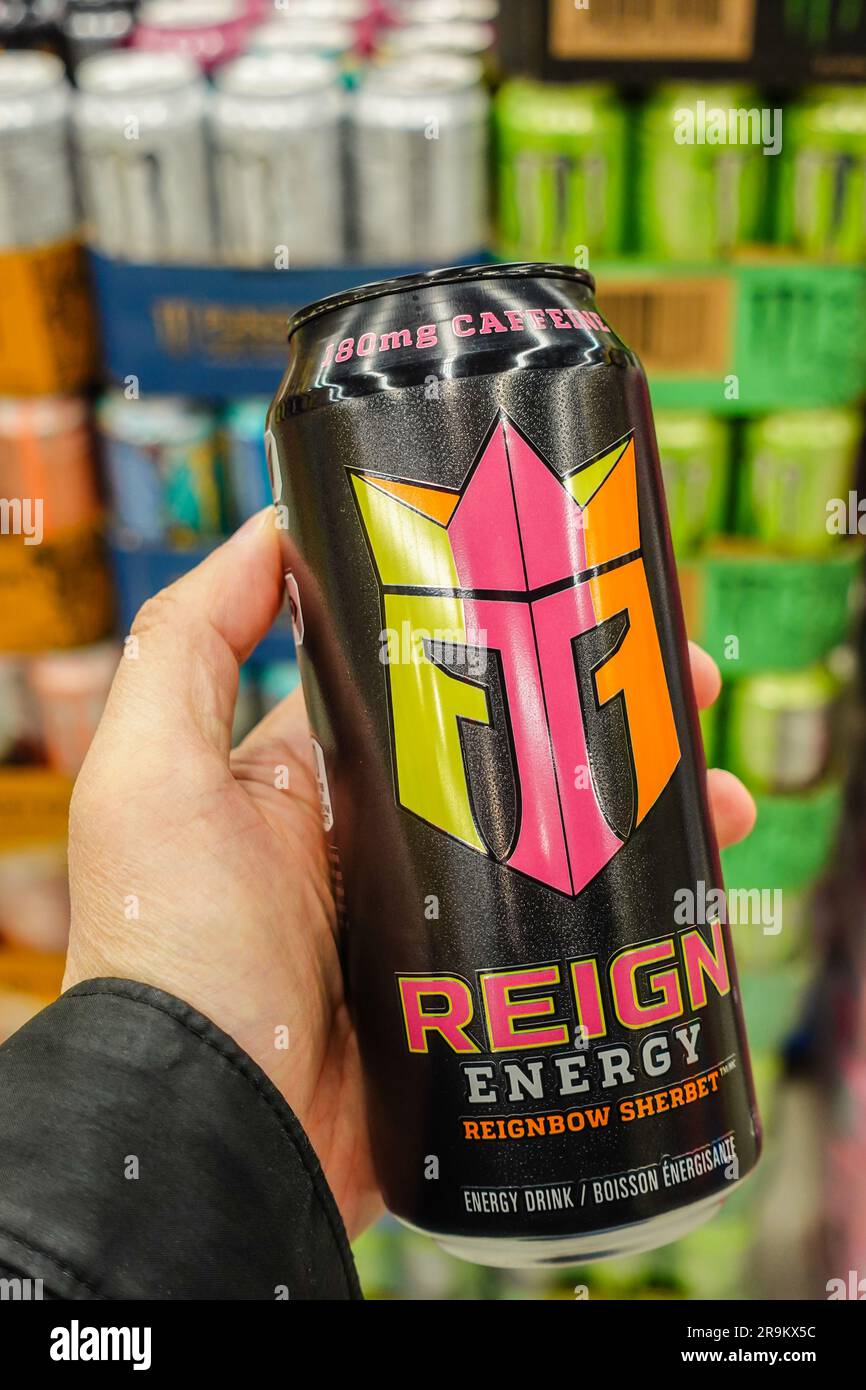 Hand holding a can of monster energy drink in the grocery store Stock ...