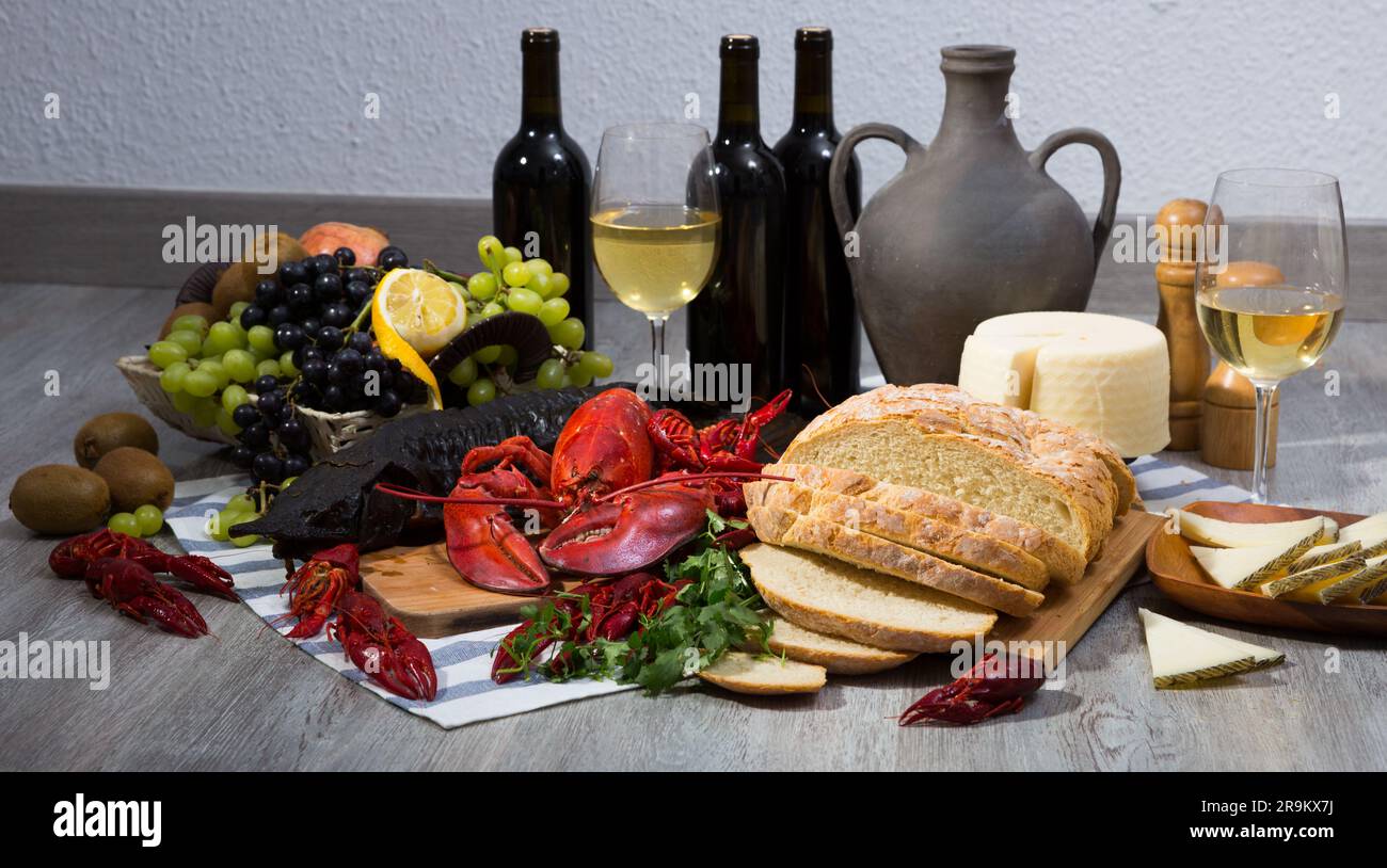 Still life with tasty seafood, wine, cheese and bread Stock Photo - Alamy