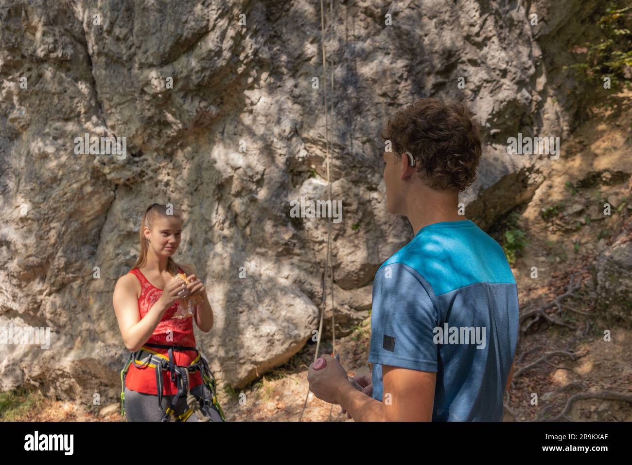 The Male climber teaching a female friend to tie a rope Stock Photo - Alamy