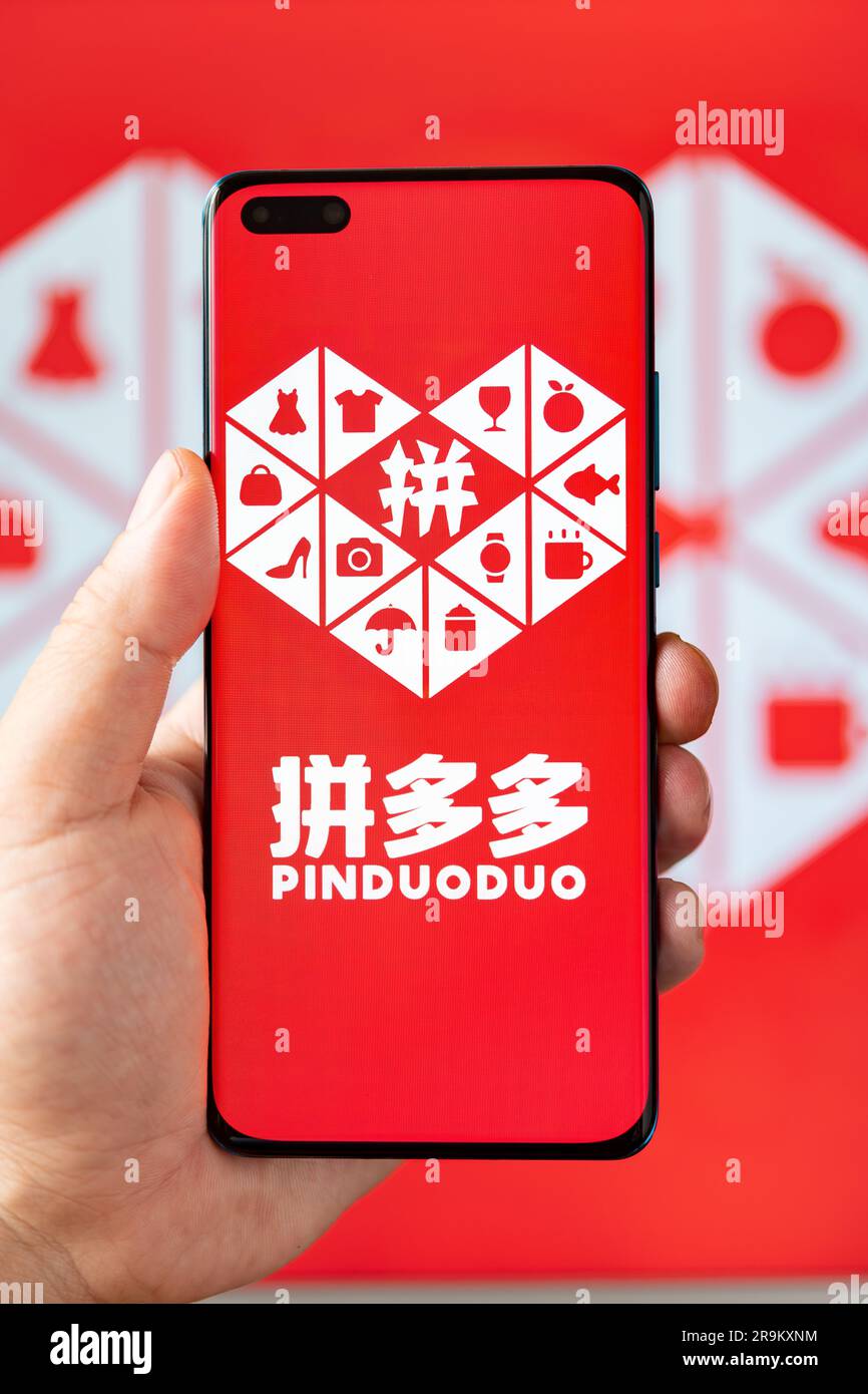 ZHONGSHAN China-June 26,2023:man holding a mobile with PinDuoDuo logo ...
