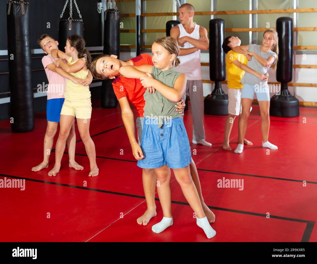 Kids in pairs training elbow strike Stock Photo - Alamy