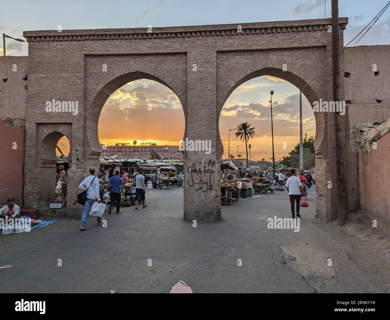 Scenic sunset at a double gate of the city wall of Marrakesh, Morocco ...