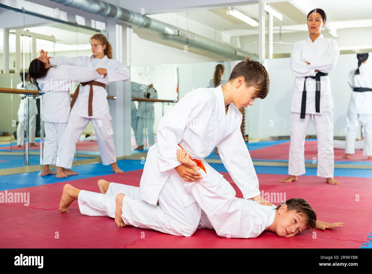 Boys performing arm lock movement during karate training Stock Photo ...