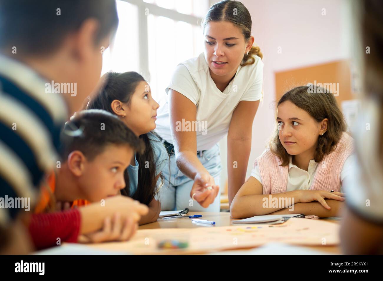 Teacher and pupils playing board game in school Stock Photo - Alamy