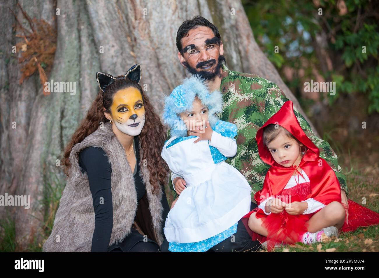 Real family having fun while using costumes of the Little red riding ...