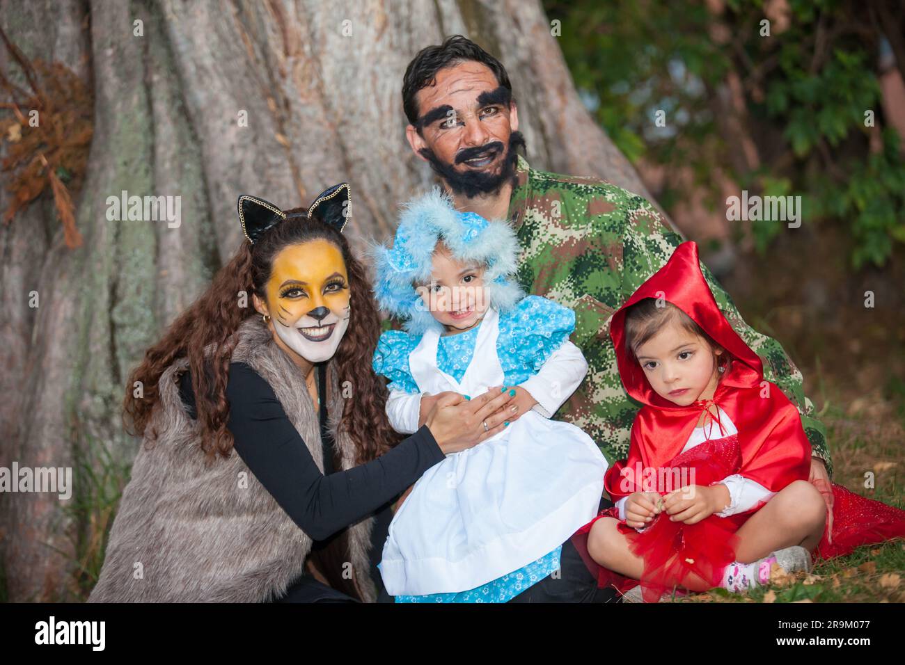 Real family having fun while using costumes of the Little red riding ...