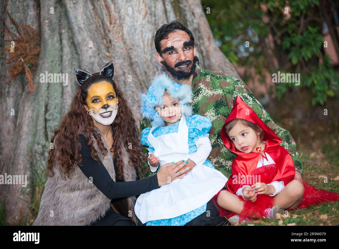 Real family having fun while using costumes of the Little red riding ...