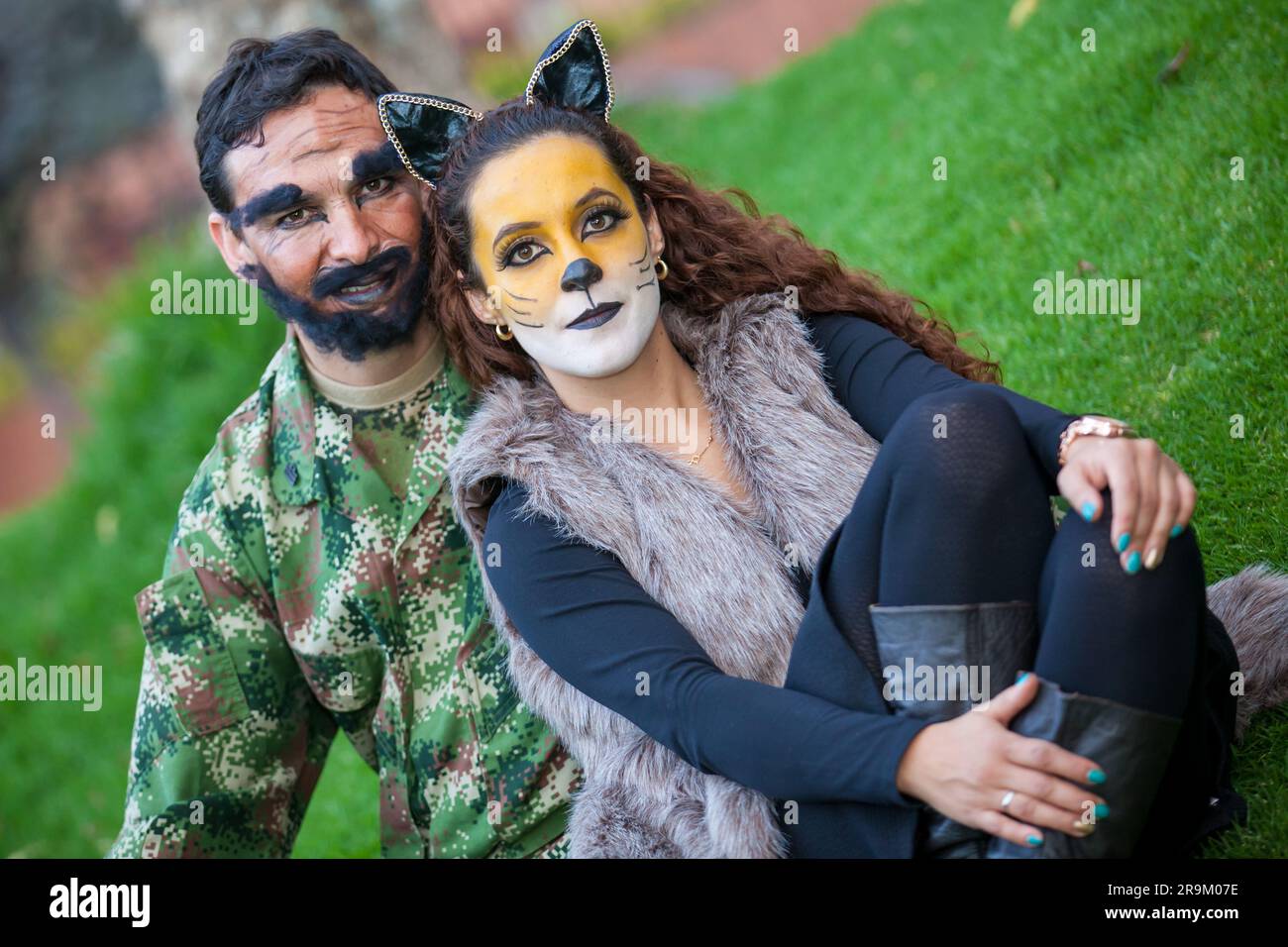 Young couple wearing wolf and woodcutter costumes. Real family having ...