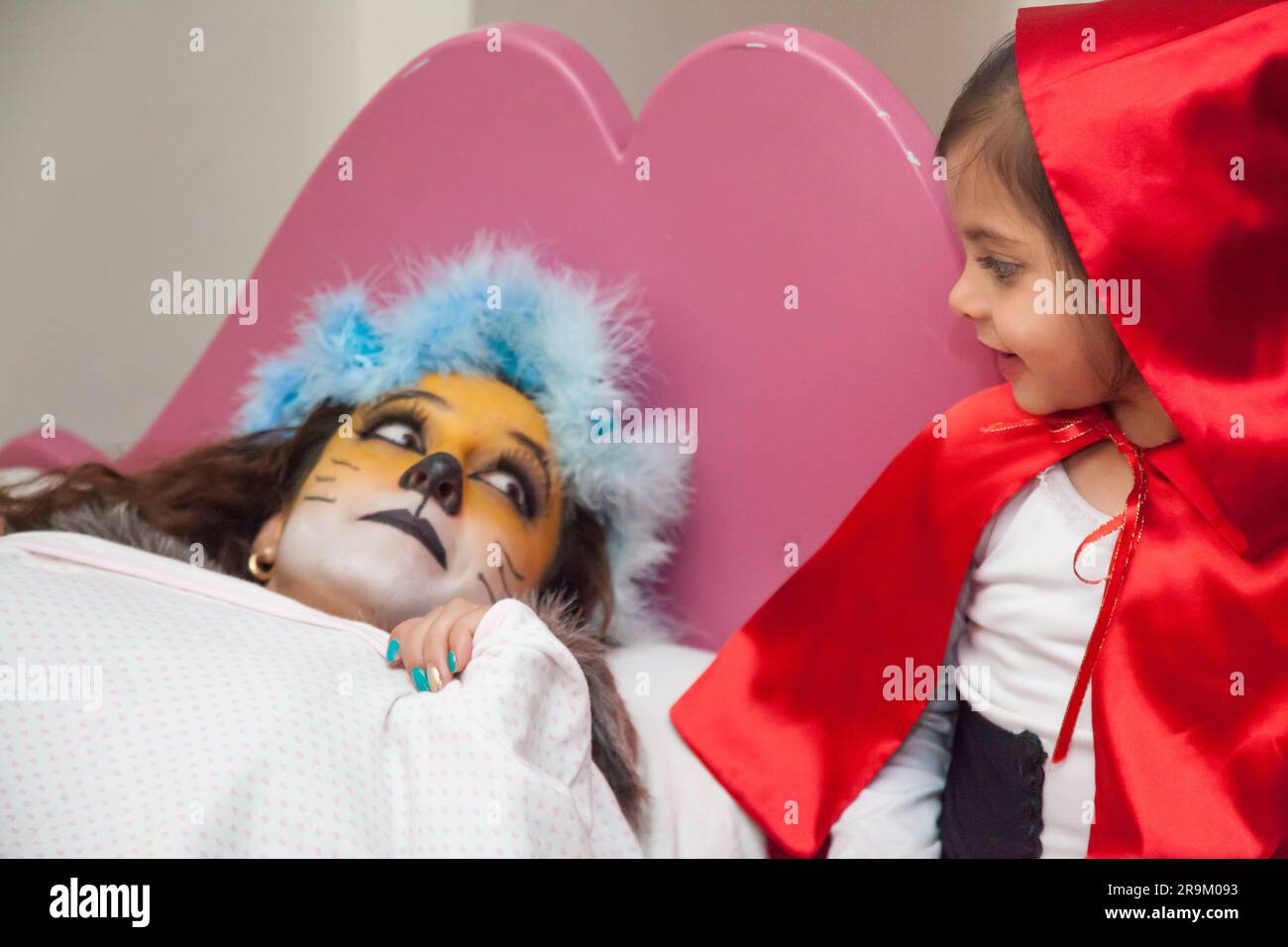 Real family having fun while using costumes of the Little red riding ...