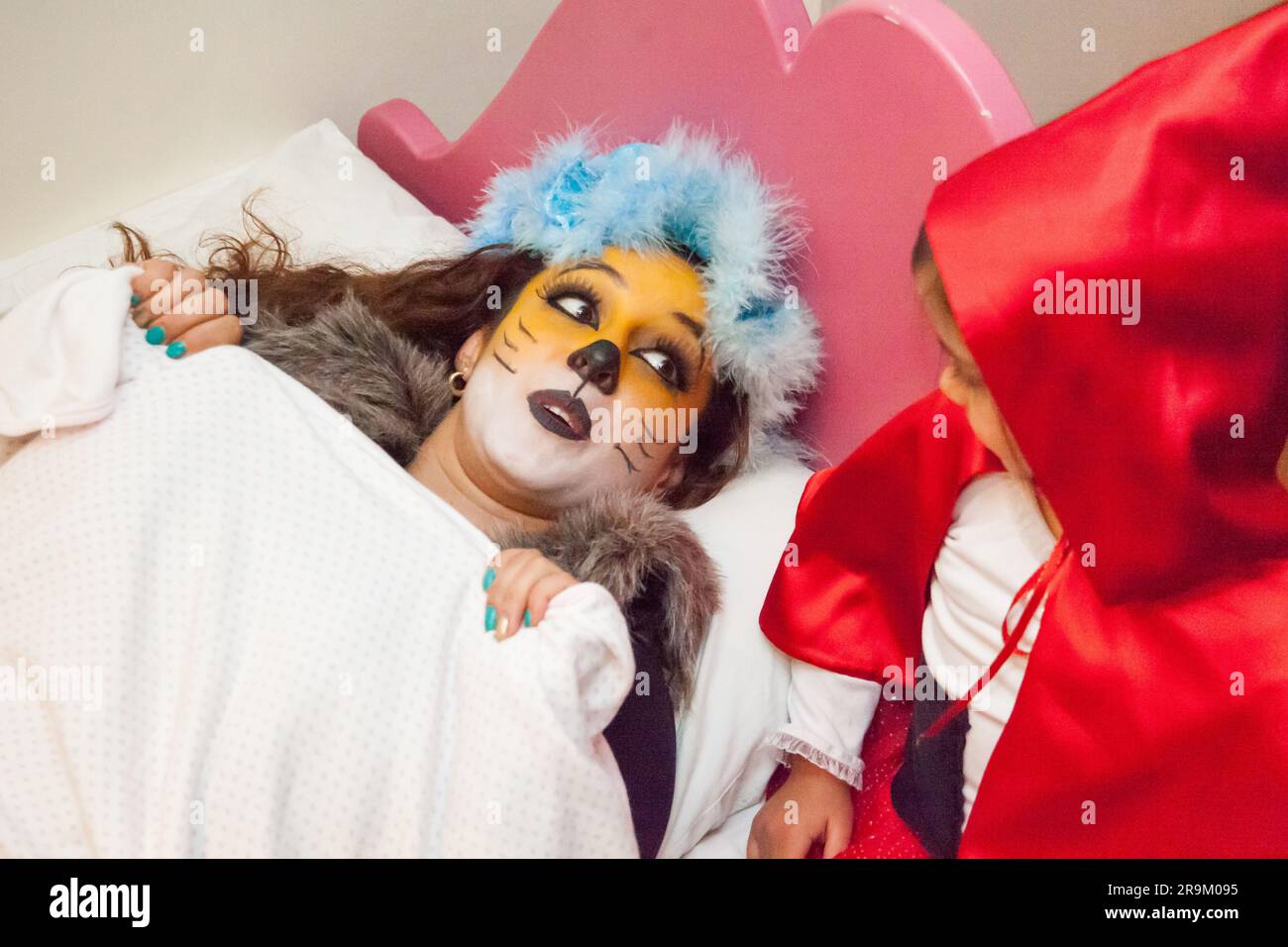 Real family having fun while using costumes of the Little red riding ...