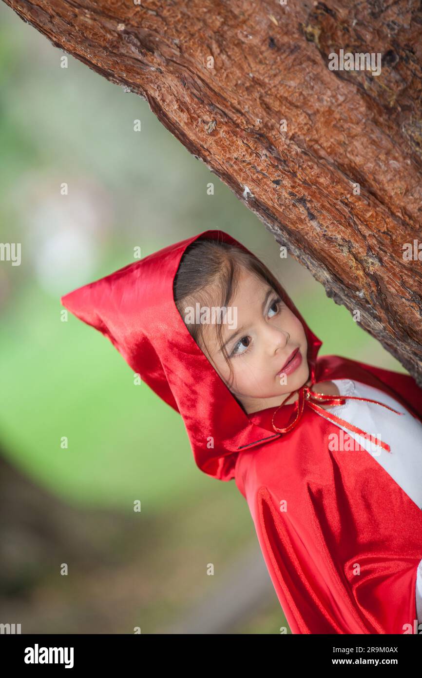 Sweet girl wearing a Little red riding hood costume. Real family having ...