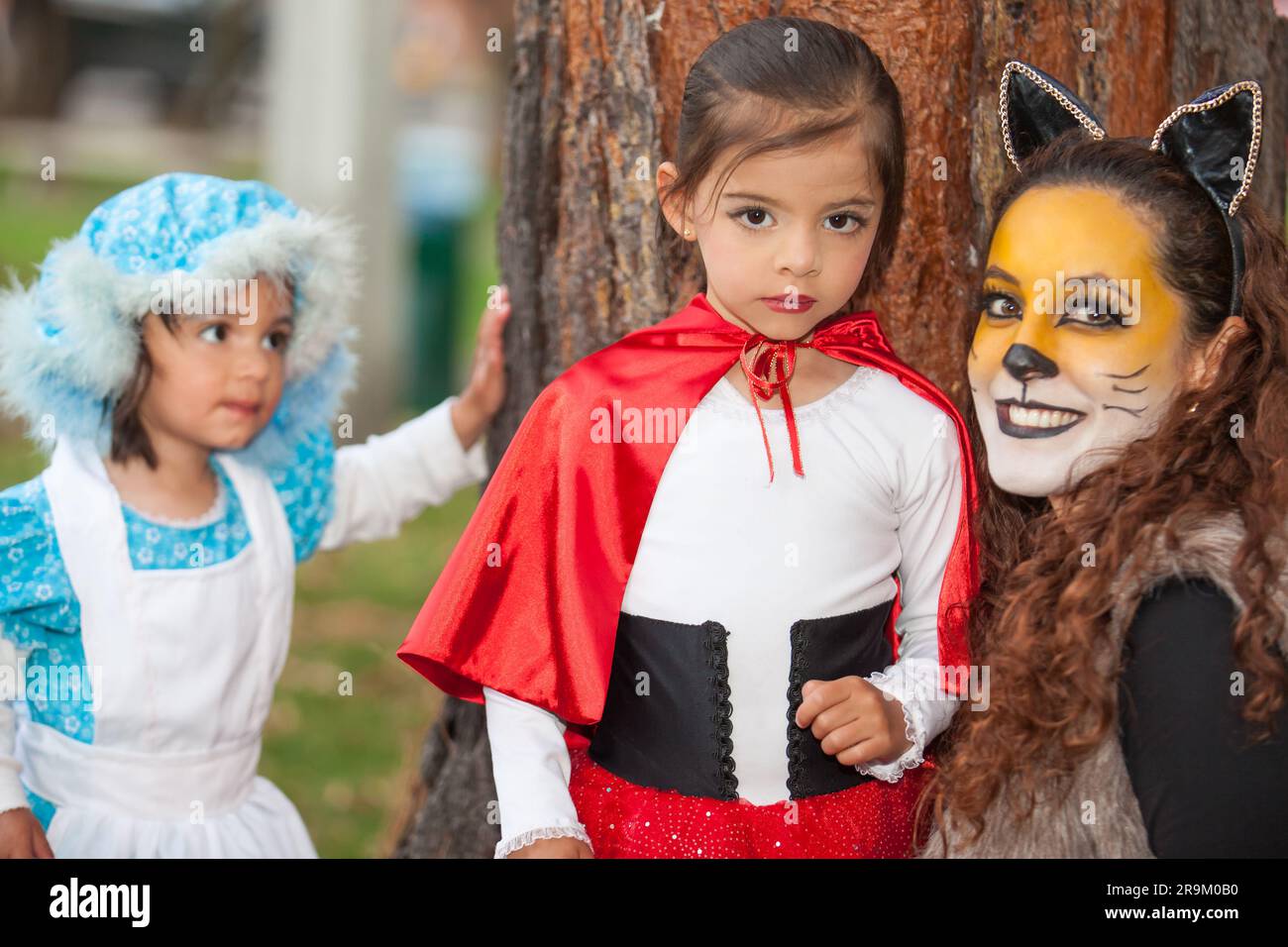Real family having fun while using costumes of the Little red riding ...